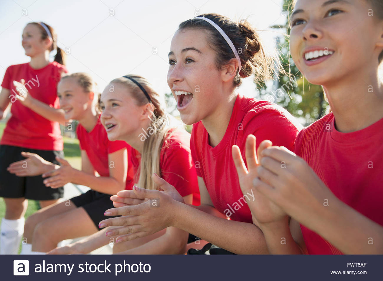 Soccer players cheering from the bench Stock Photo - Alamy
