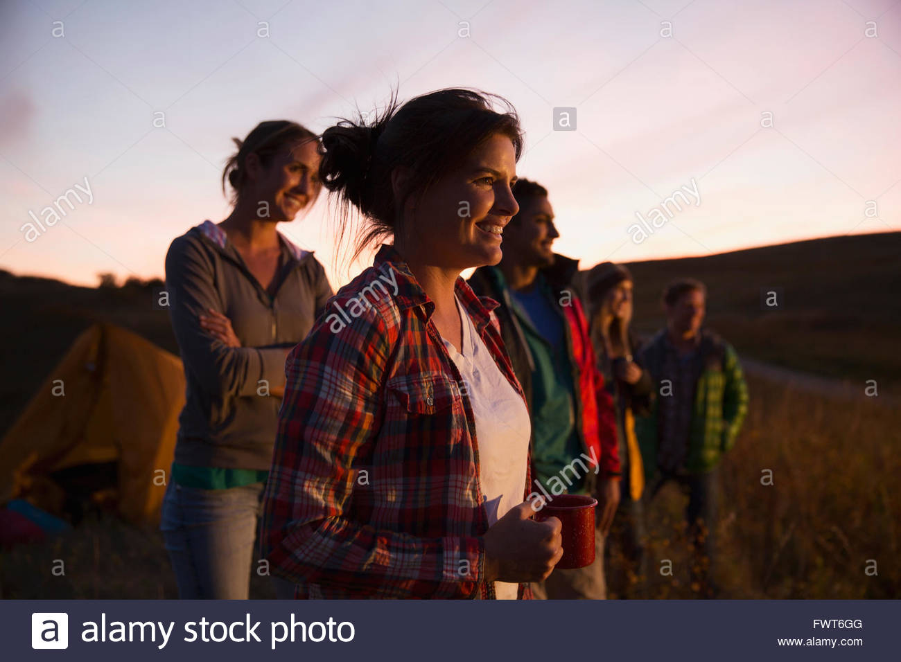 Friends standing in field and looking out Stock Photo - Alamy