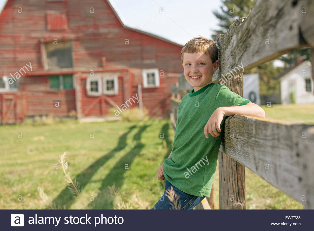 Boy leaning on fence hi-res stock photography and images - Alamy