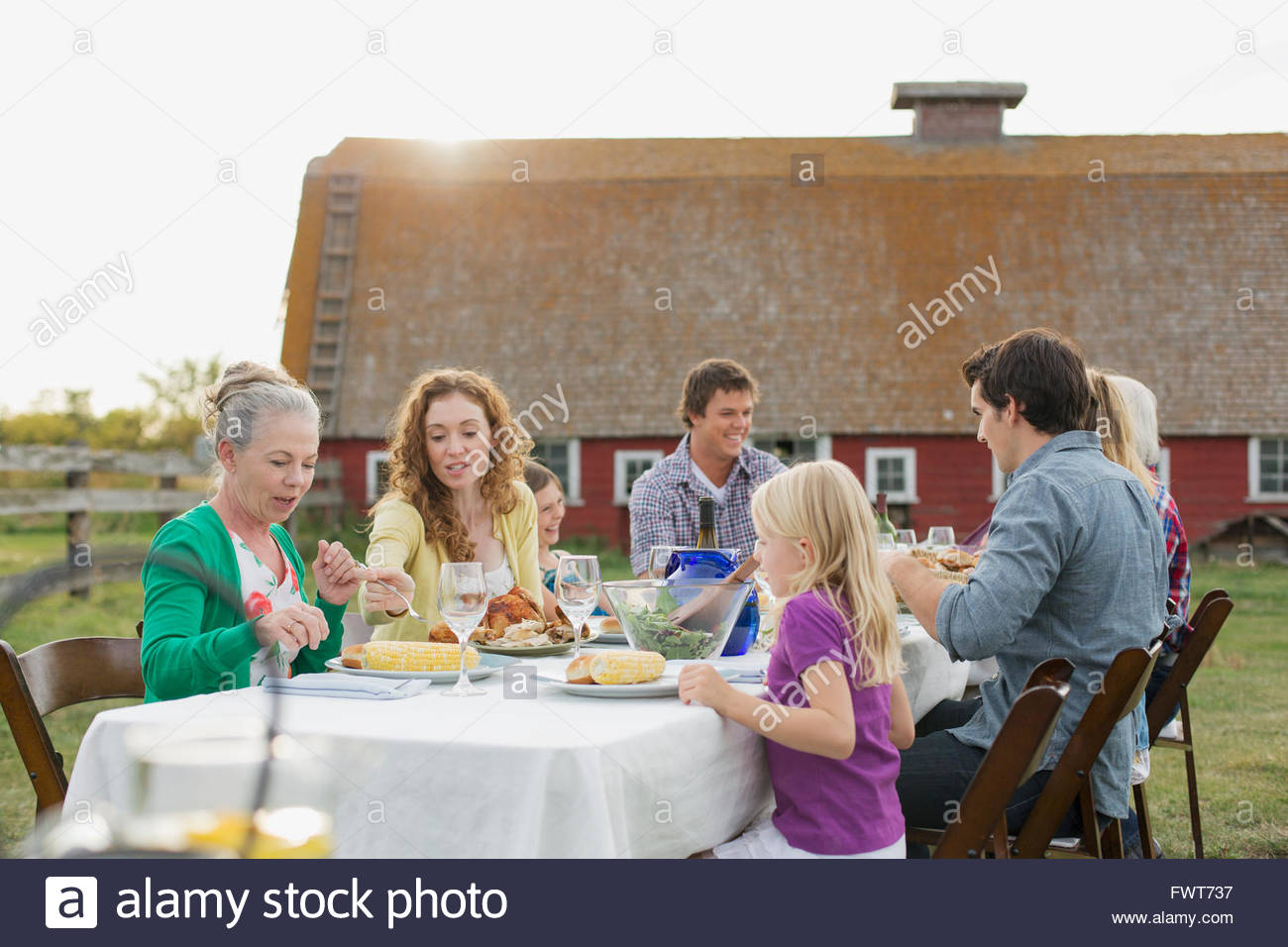 Family enjoying a meal outdoors on rural property Stock Photo - Alamy