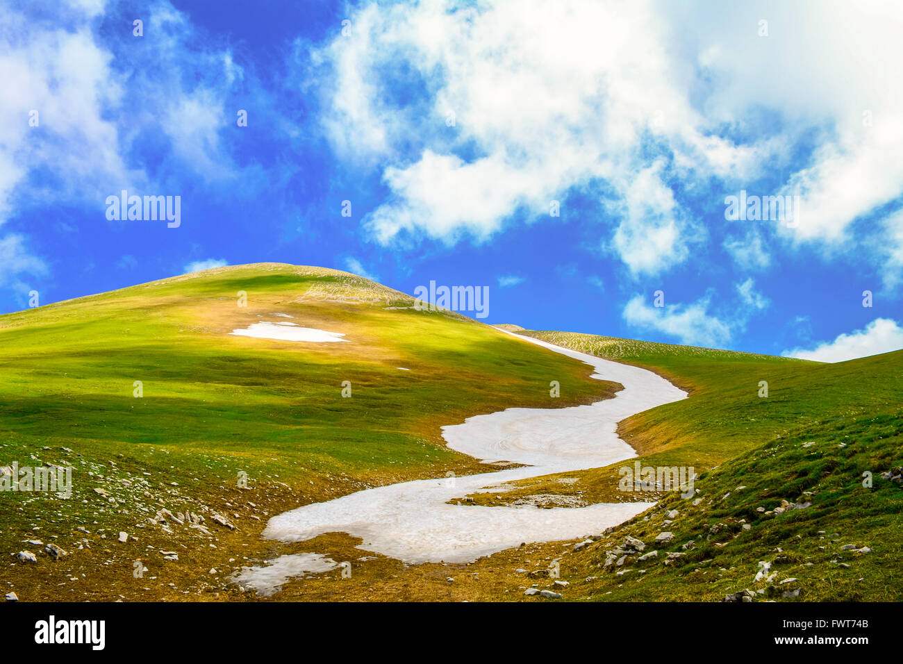 Remaining snow in summer along the top of a mountain Stock Photo - Alamy