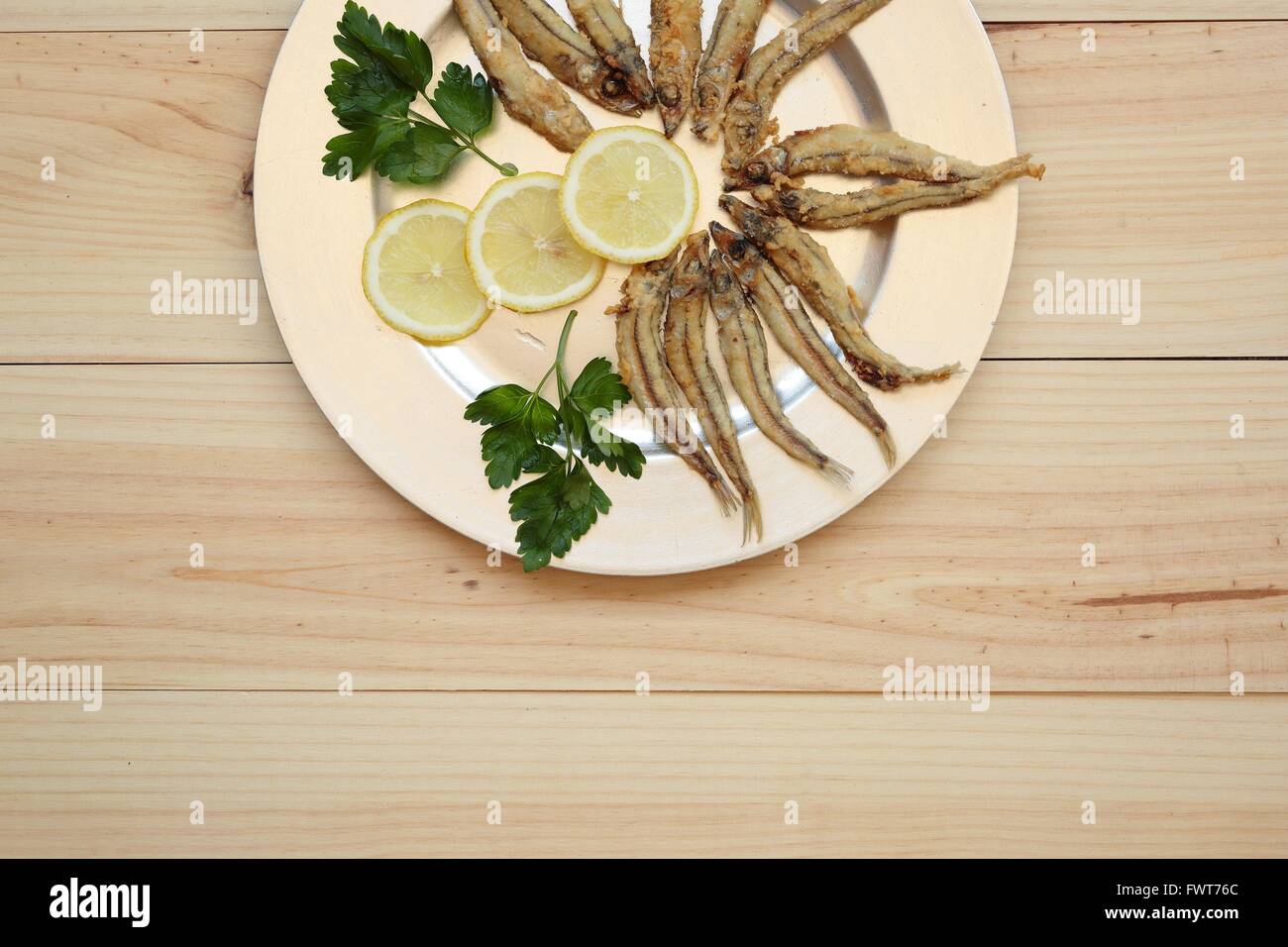 Fried fish with lemon on a silver tray Stock Photo - Alamy