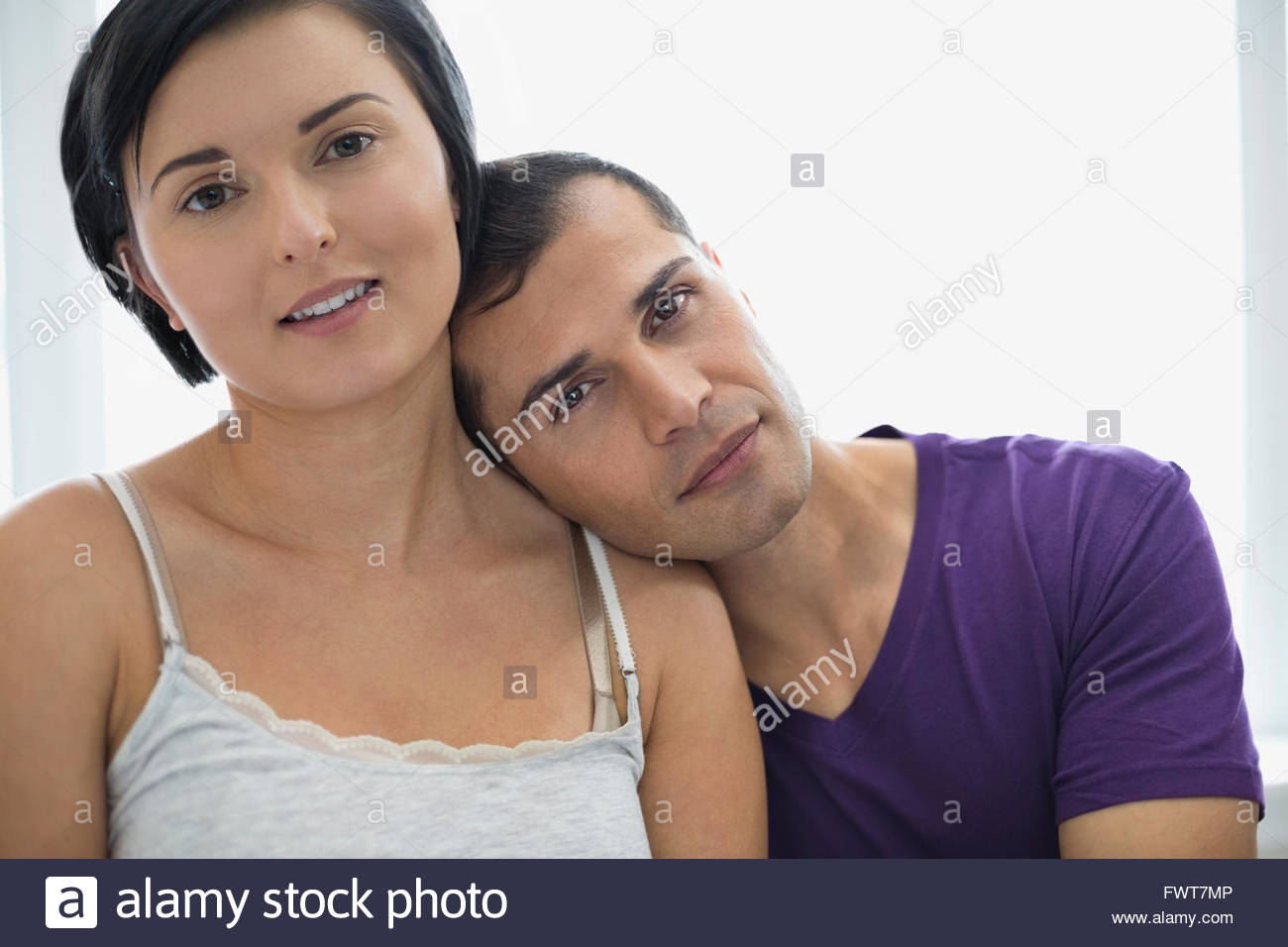 Portrait of man resting head on wife's shoulder Stock Photo - Alamy