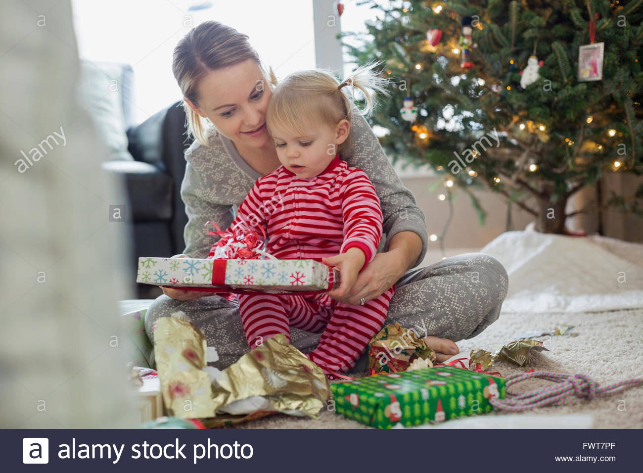 Mother and daughter unwrapping Christmas gifts Stock Photo - Alamy