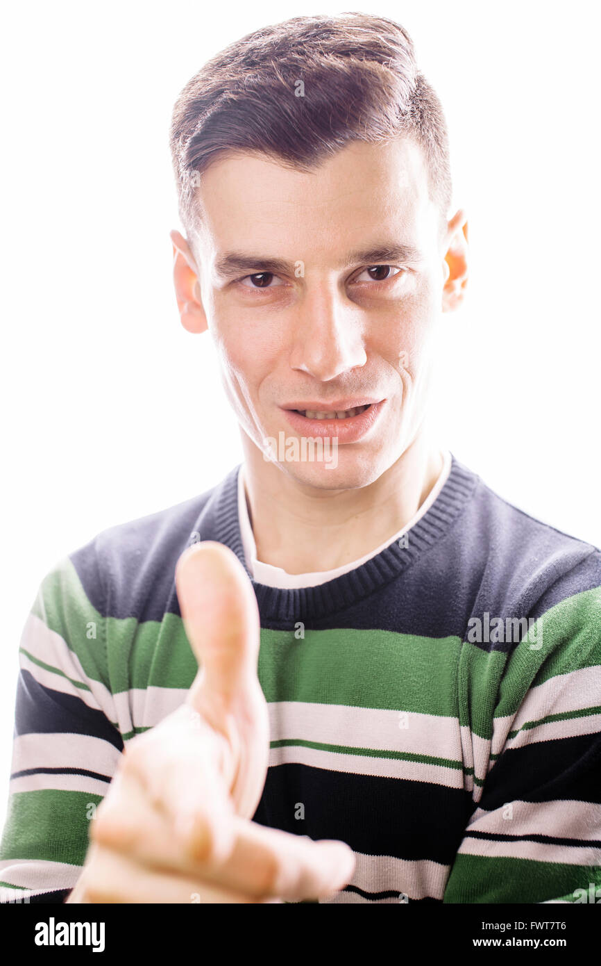Portrait of a smart serious young man standing against white background ...