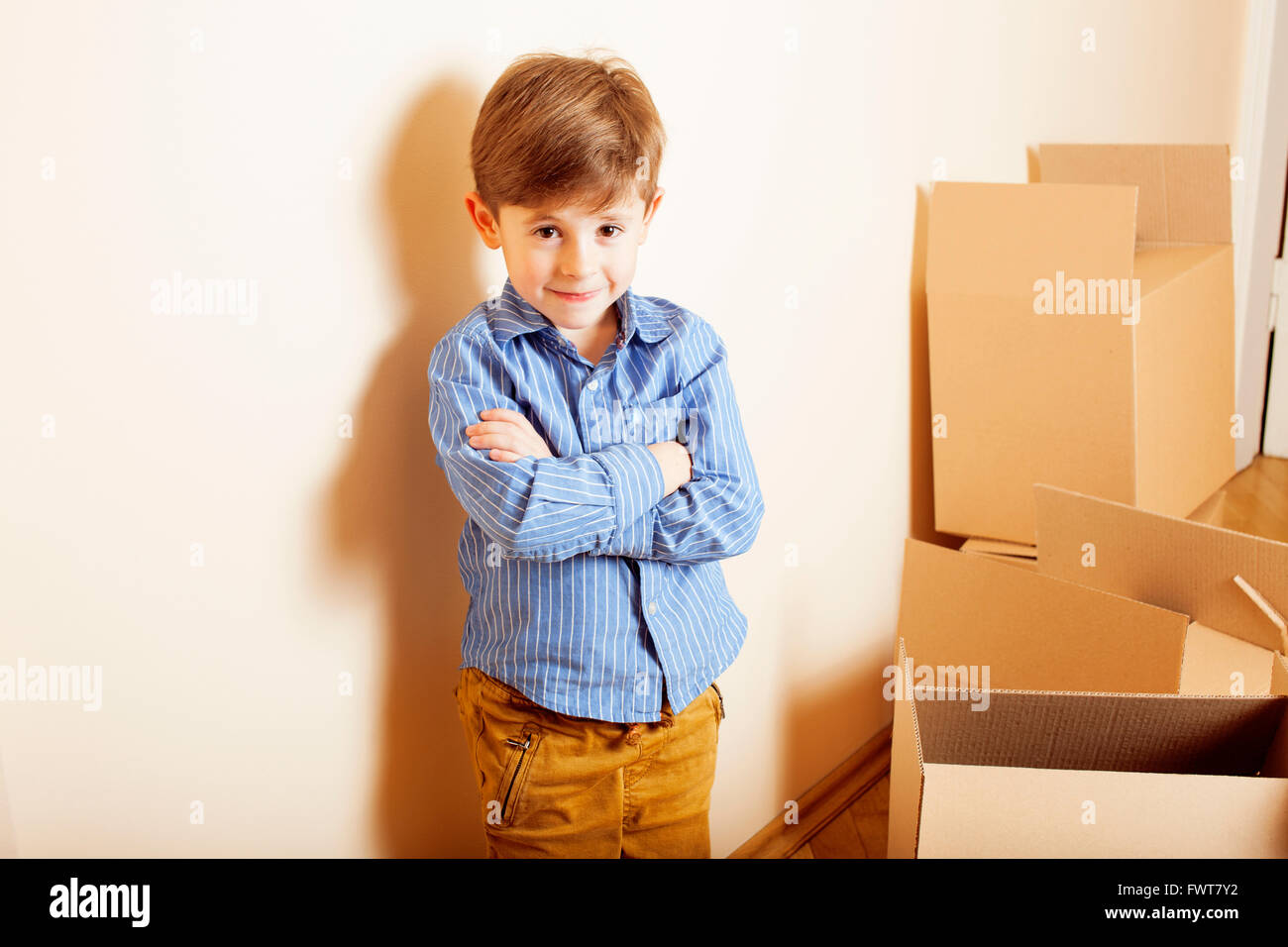little cute boy in empty room, remoove to new house. home alone emong ...