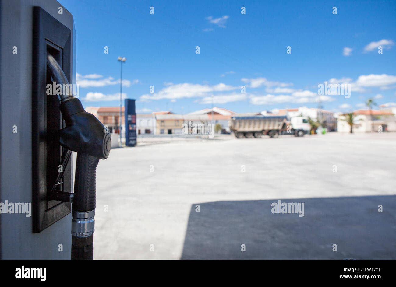 Closeup of a gas station handle nozzle with a truck at the bottom Stock ...