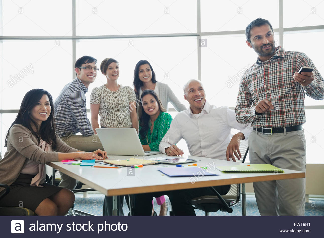 Businessman presenting to colleagues hi-res stock photography and ...