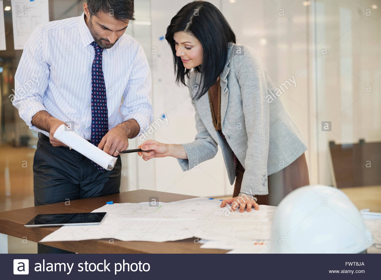 Colleagues reviewing paperwork together Stock Photo - Alamy Colleagues reviewing paperwork together Stock Photo - Alamy