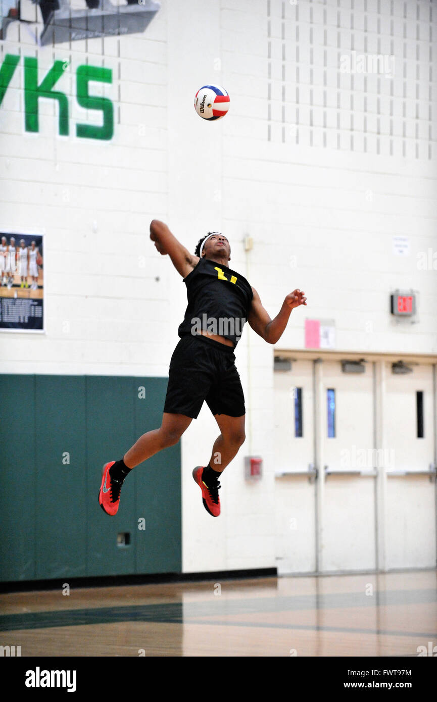 Player delivering a power serve during a high school volleyball match ...