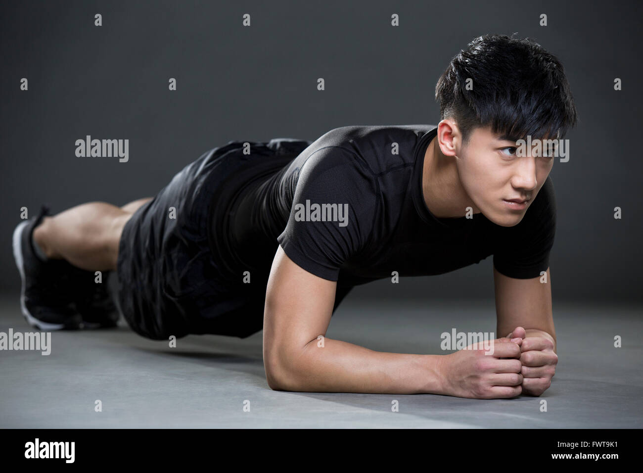 Young man doing plank exercise Stock Photo - Alamy