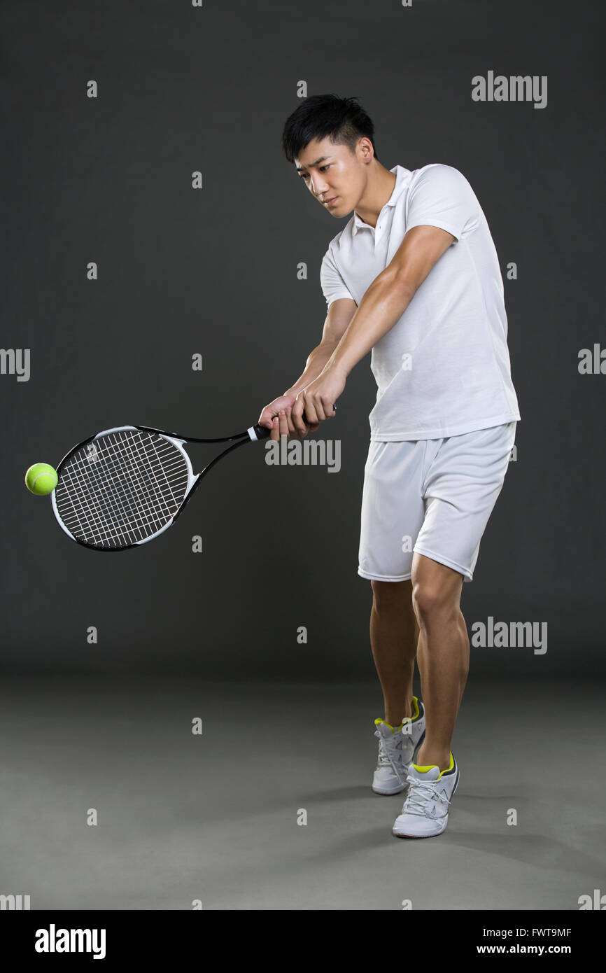 Young man playing tennis Stock Photo - Alamy