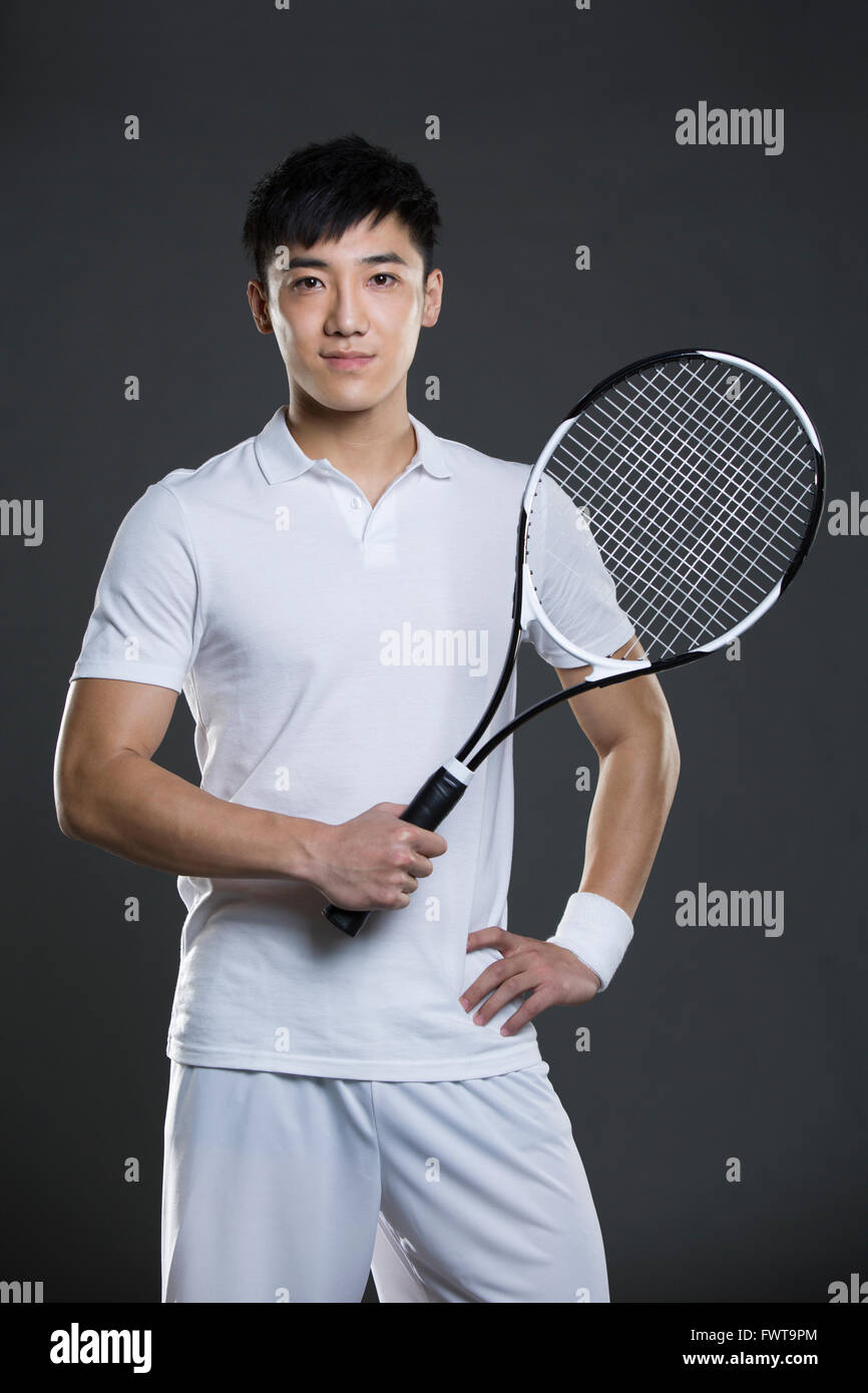 Young man holding tennis racket Stock Photo - Alamy