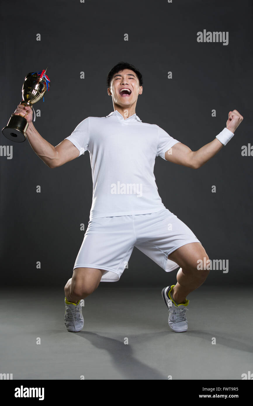 Asian man holding trophy hi-res stock photography and images - Alamy