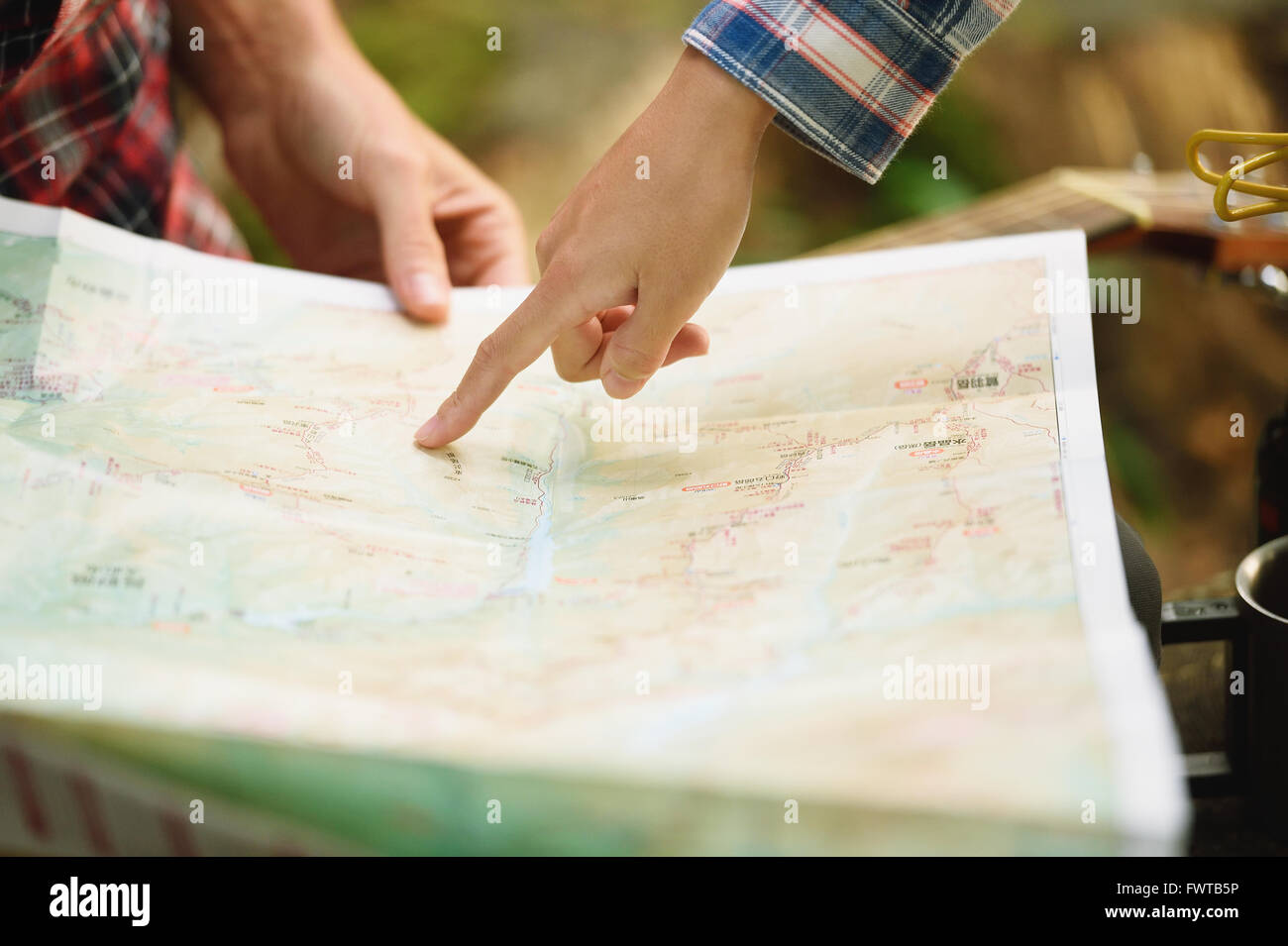 Friends checking map at a camp site Stock Photo - Alamy