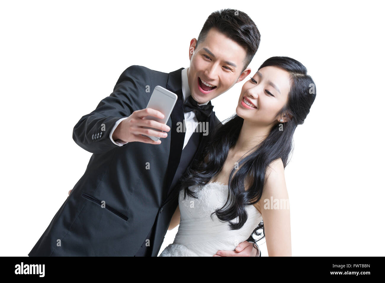Happy bride and groom taking self portrait with smart phone Stock Photo ...