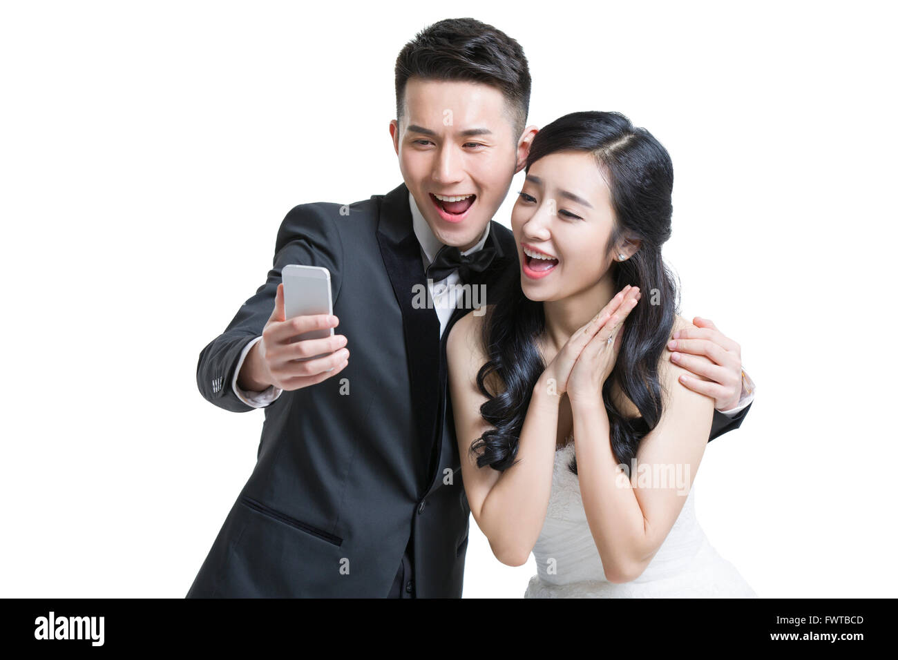 Happy bride and groom taking self portrait with smart phone Stock Photo ...