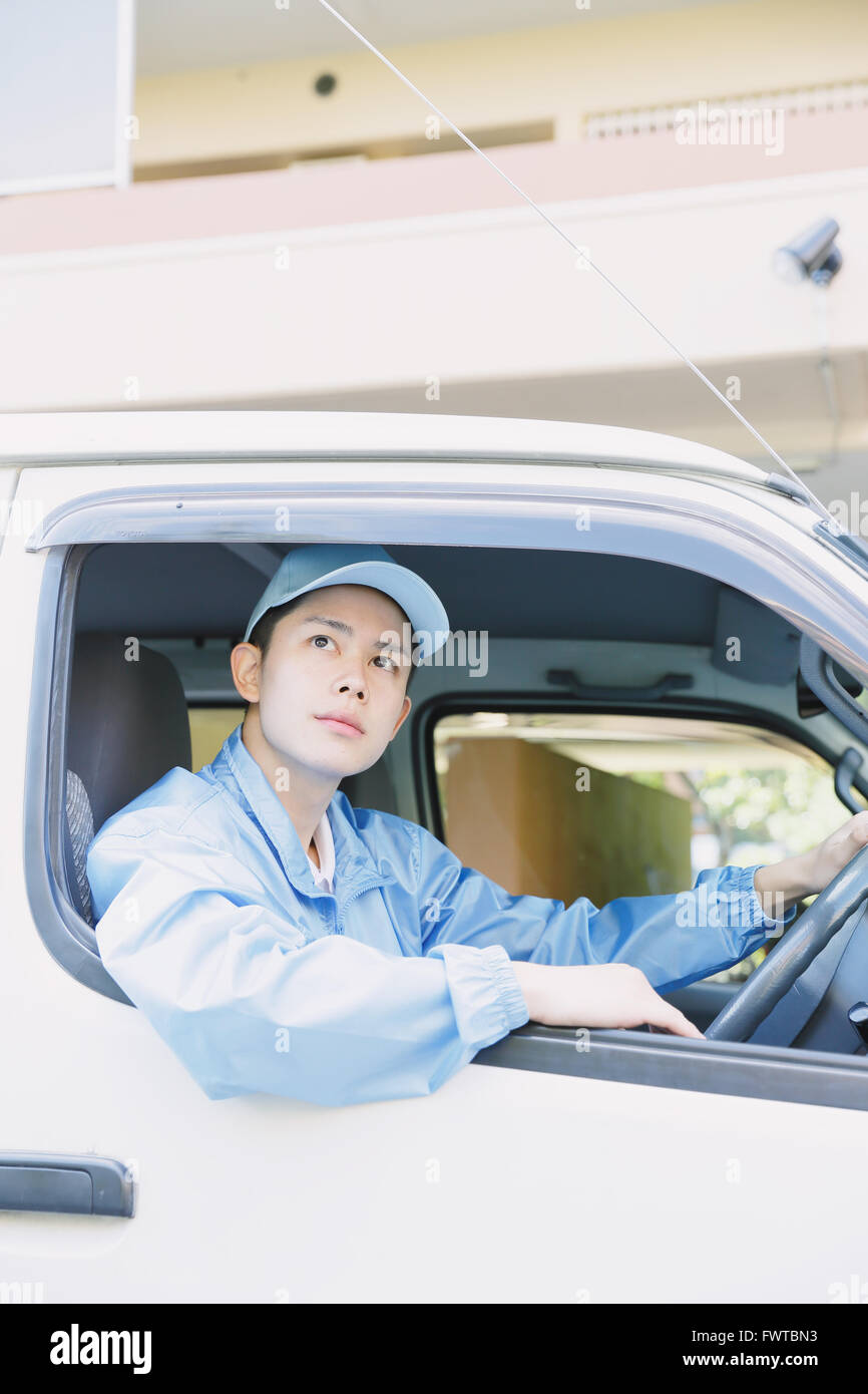 Young Japanese delivery man on his truck Stock Photo - Alamy