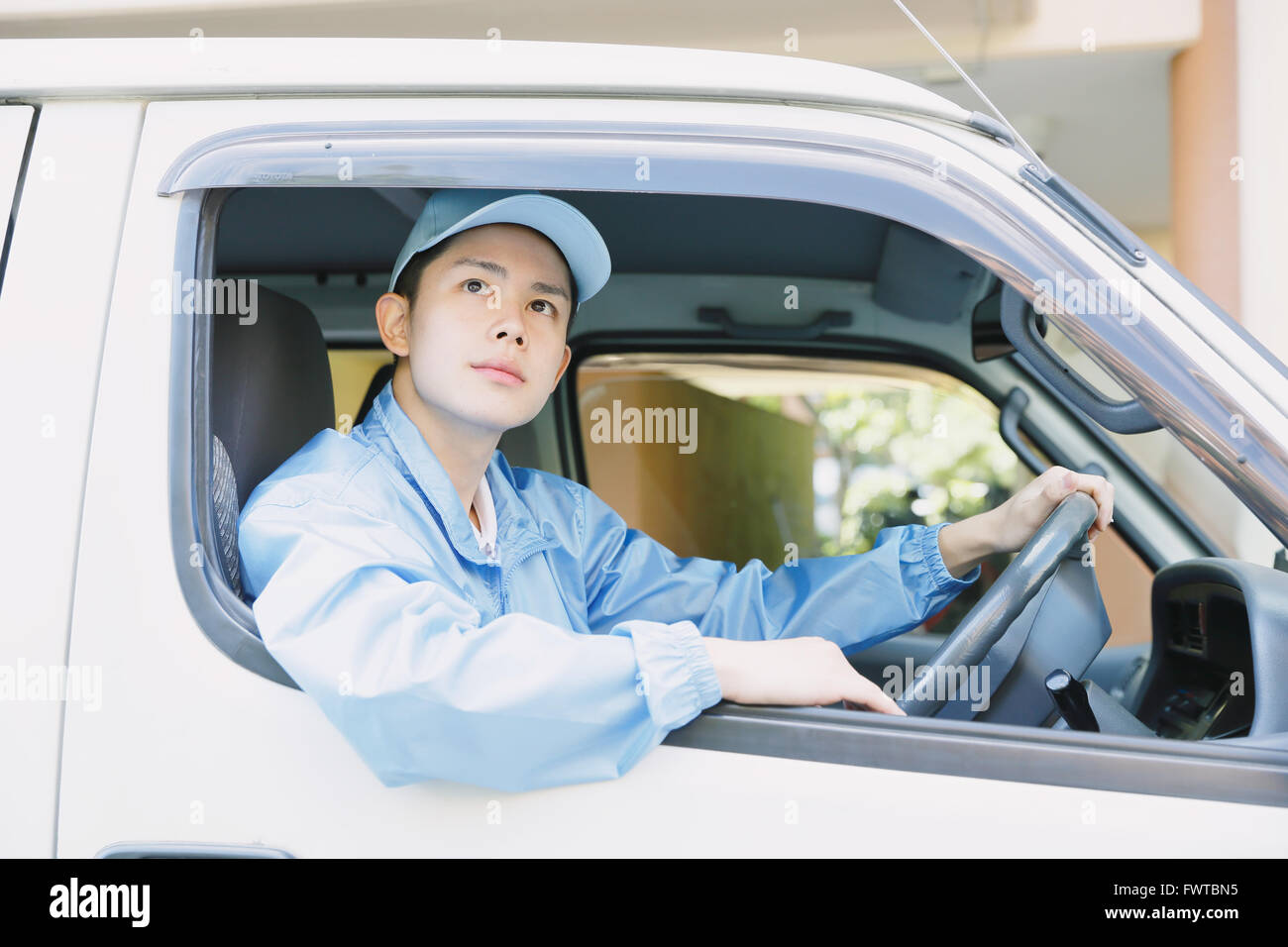 Young Japanese delivery man on his truck Stock Photo - Alamy