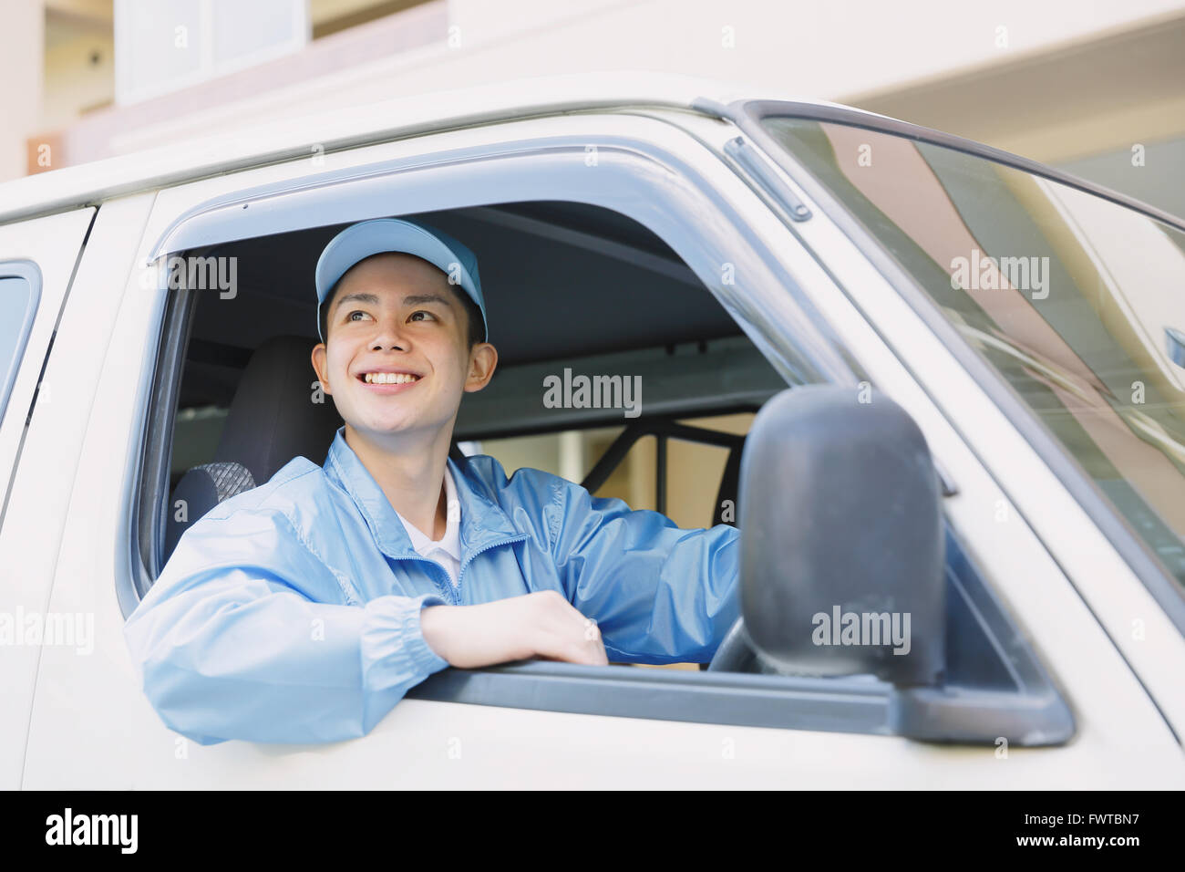 Young Japanese delivery man on his truck Stock Photo - Alamy