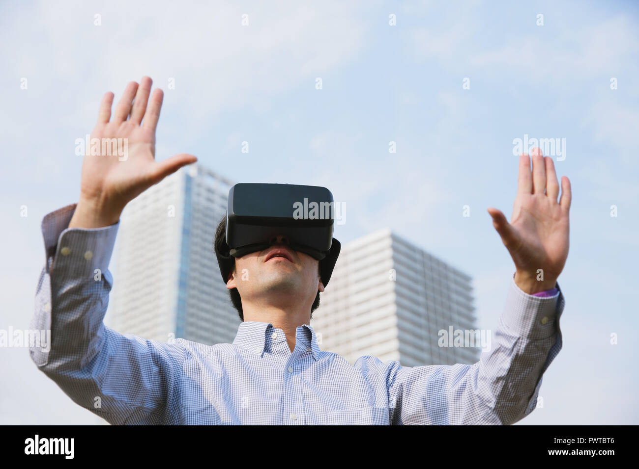 Japanese man using virtual reality device Stock Photo - Alamy