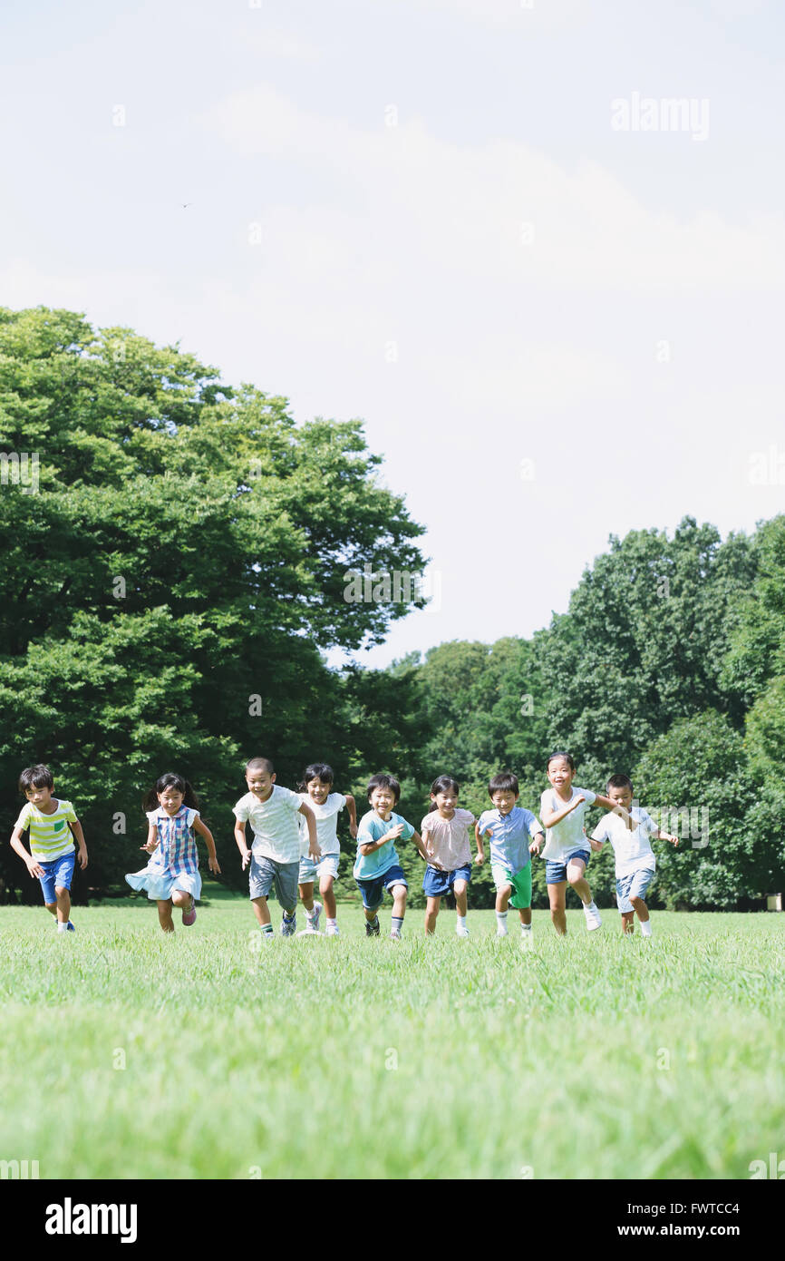 Japanese kids running in a city park Stock Photo - Alamy