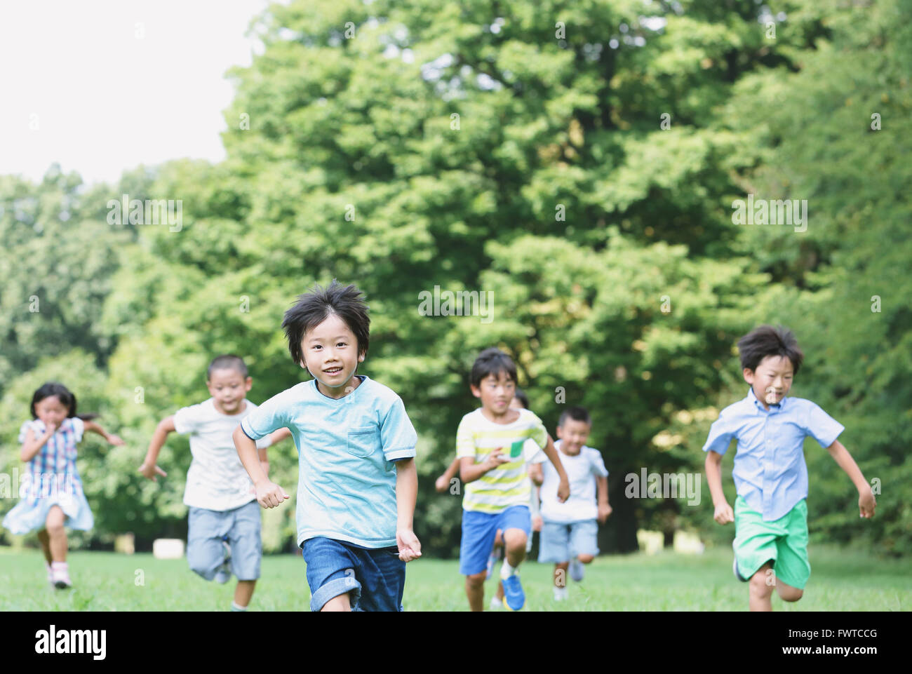 Japanese kids running in a city park Stock Photo - Alamy