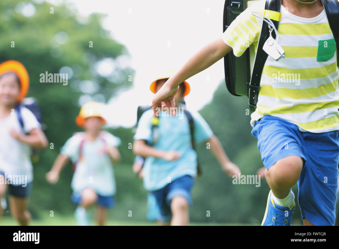 Japanese kids running in a city park Stock Photo - Alamy