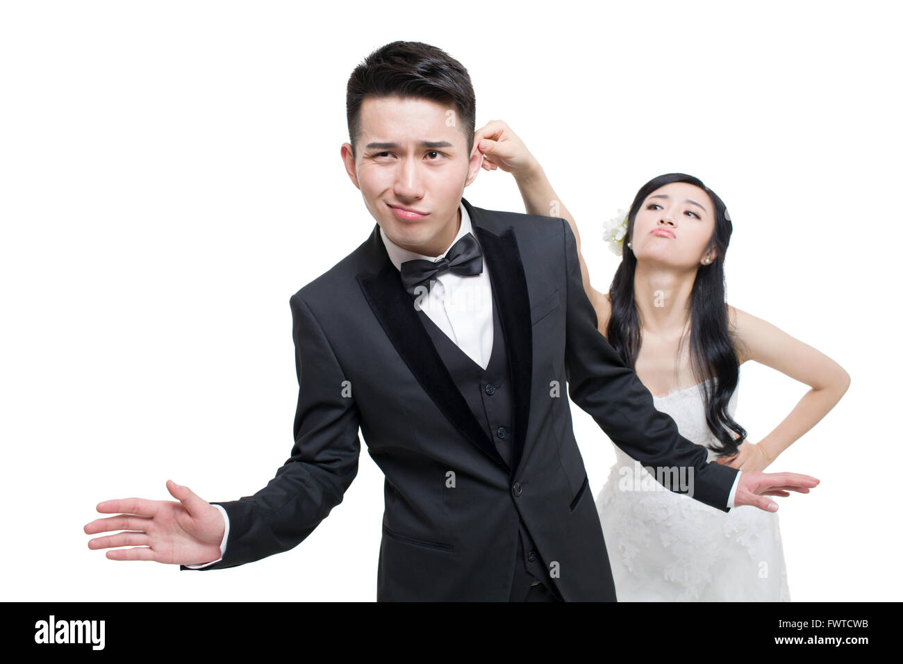Bride pulling groom's ear Stock Photo - Alamy