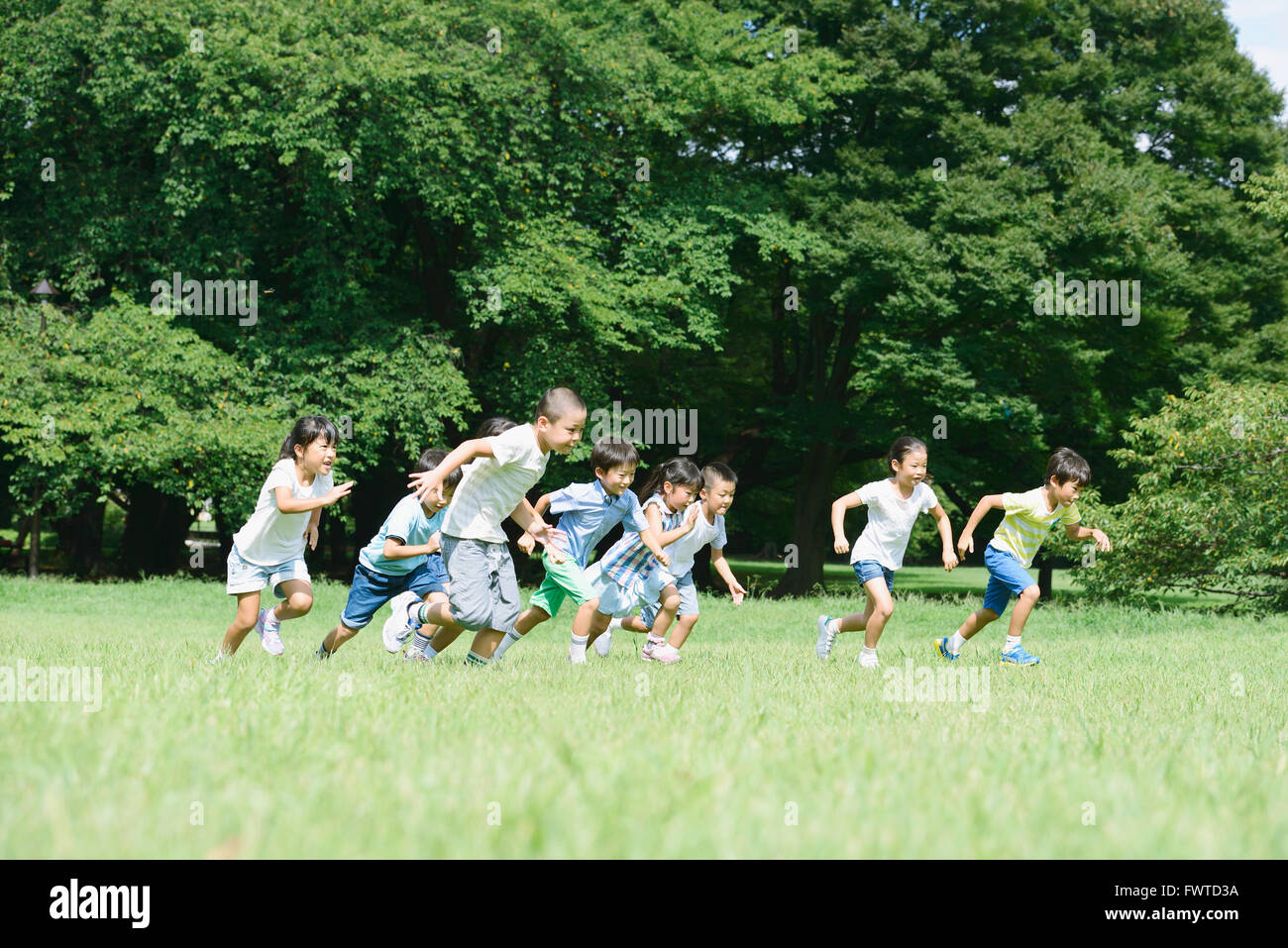 Japanese kids running in a city park Stock Photo - Alamy