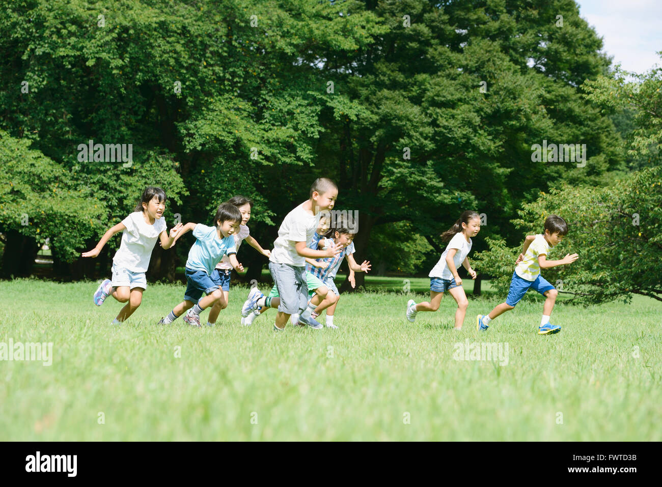 Group of children playing park running hi-res stock photography and ...