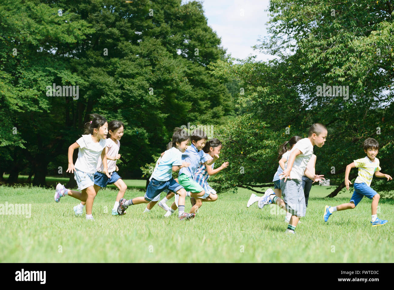 Japanese kids running in a city park Stock Photo - Alamy