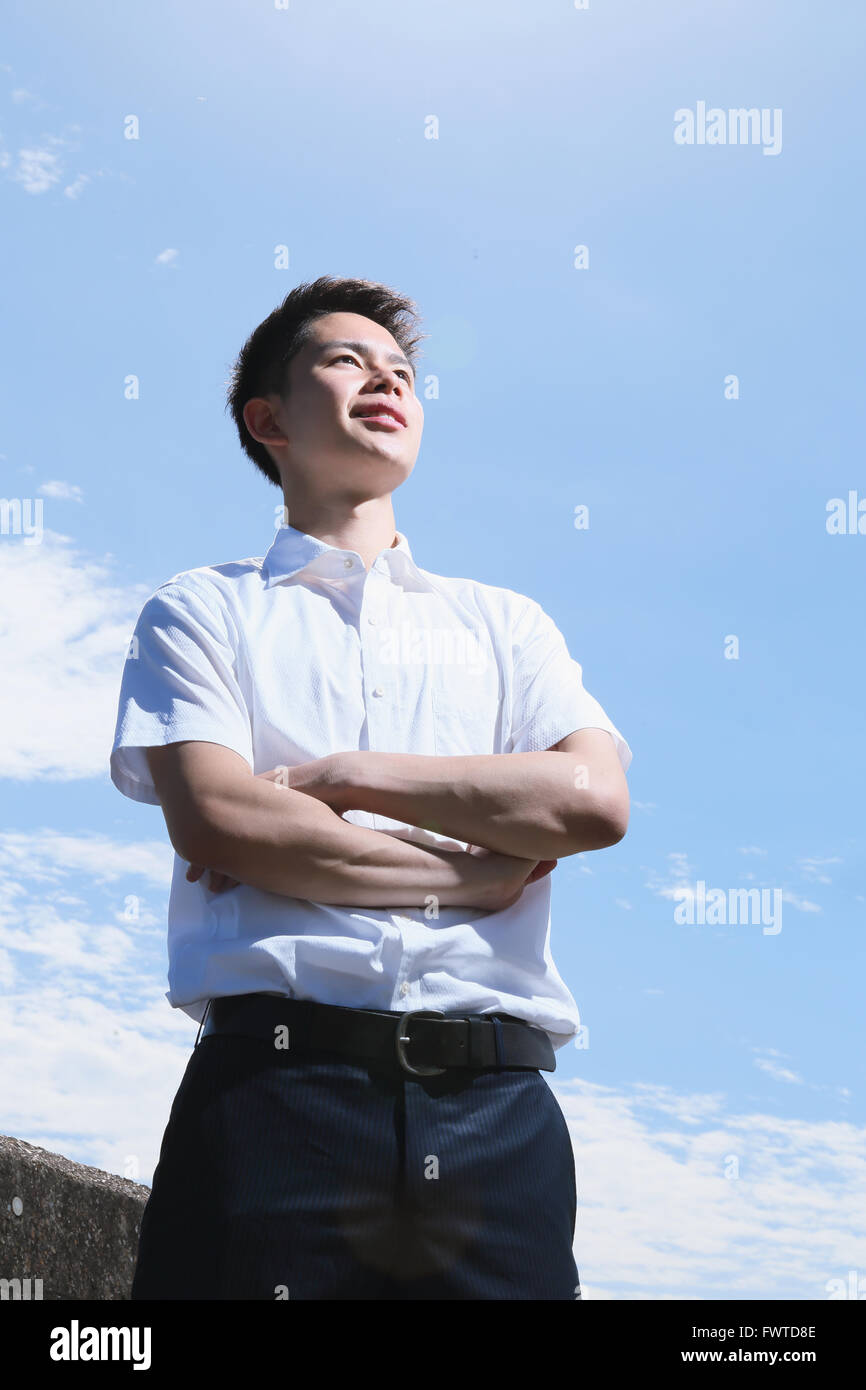 Portrait of young Japanese man by the sea Stock Photo - Alamy