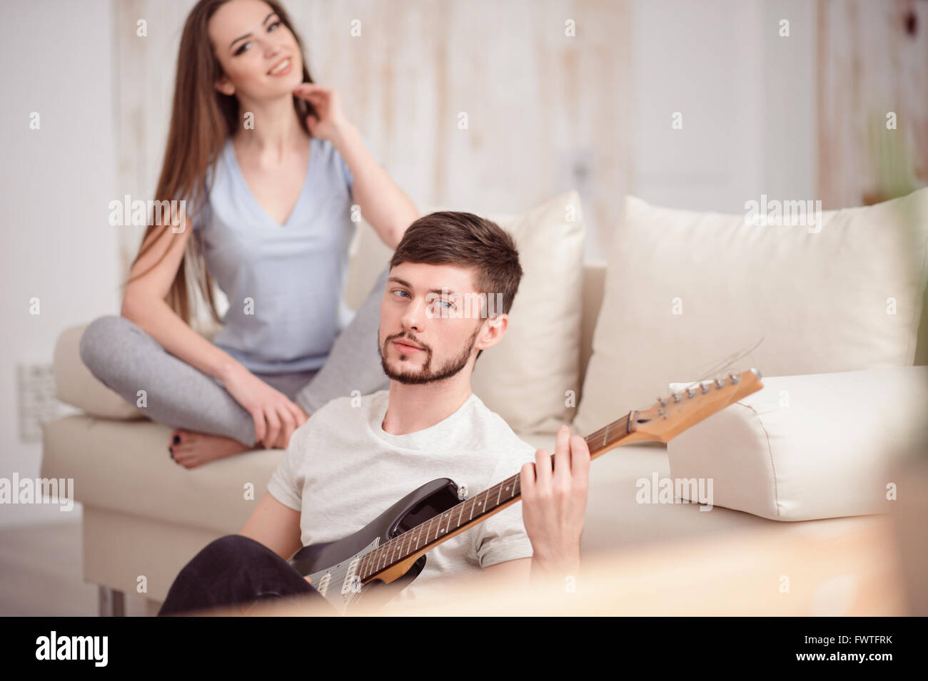 Pleasant guy playing the guitar Stock Photo - Alamy