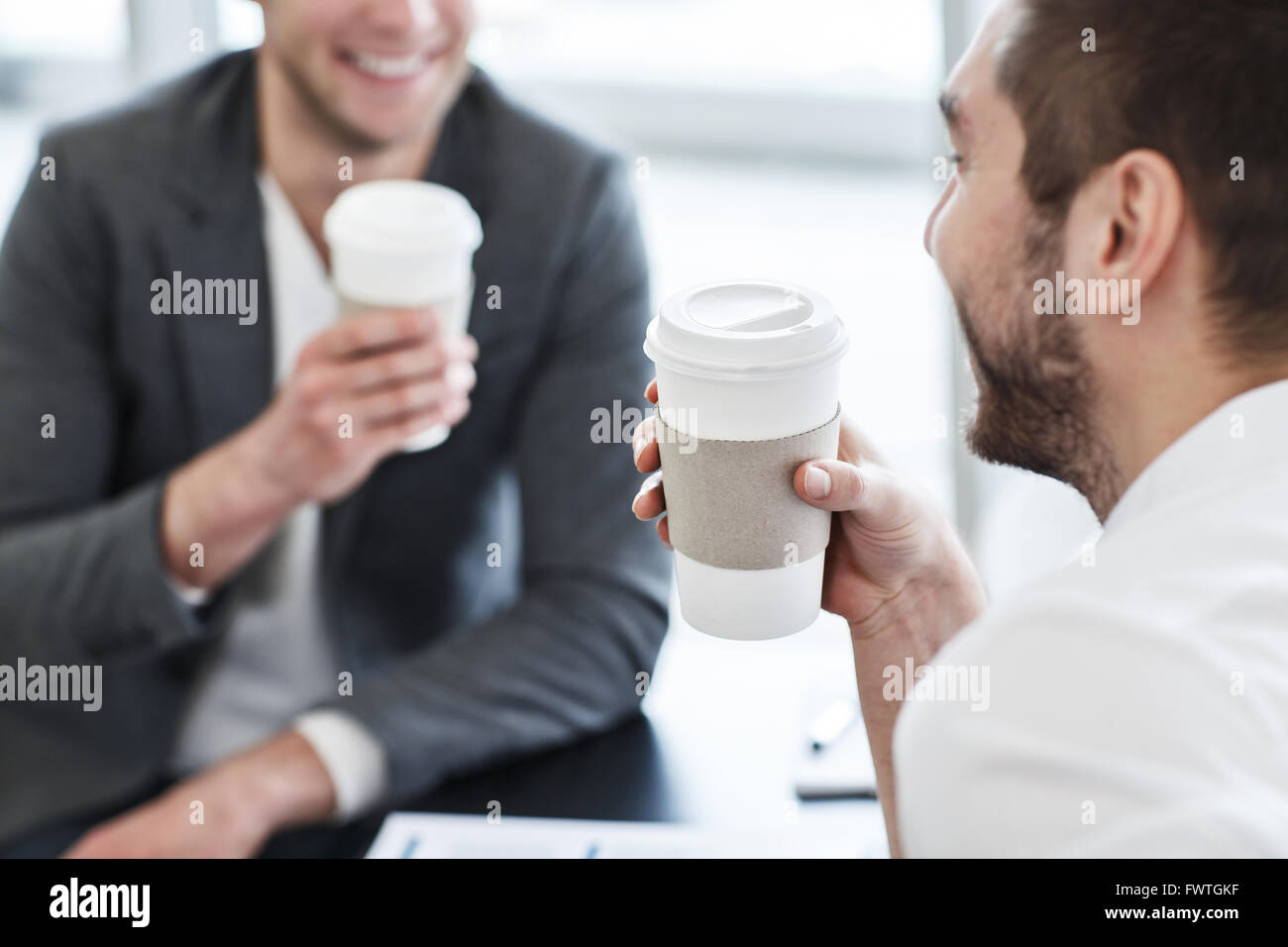 Cheerful colleagues drinking coffee Stock Photo - Alamy