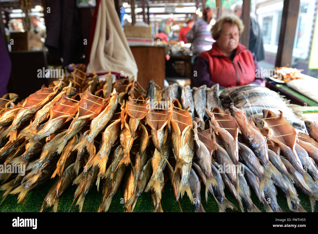 A Russian woman selling the famous smoked Omul fish in Listvyanka on ...