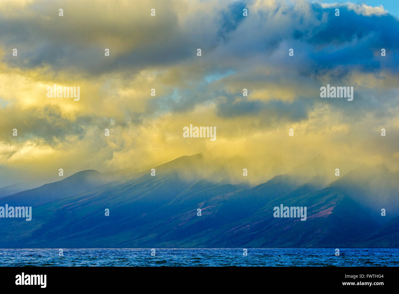 Molokai with rain clouds at sunset seen from Maui Stock Photo - Alamy