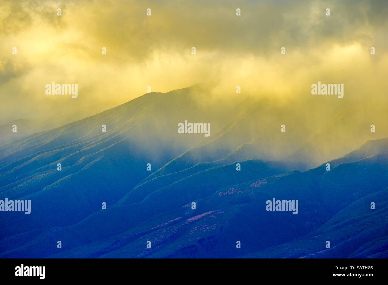 Molokai with rain clouds at sunset seen from Maui Stock Photo - Alamy