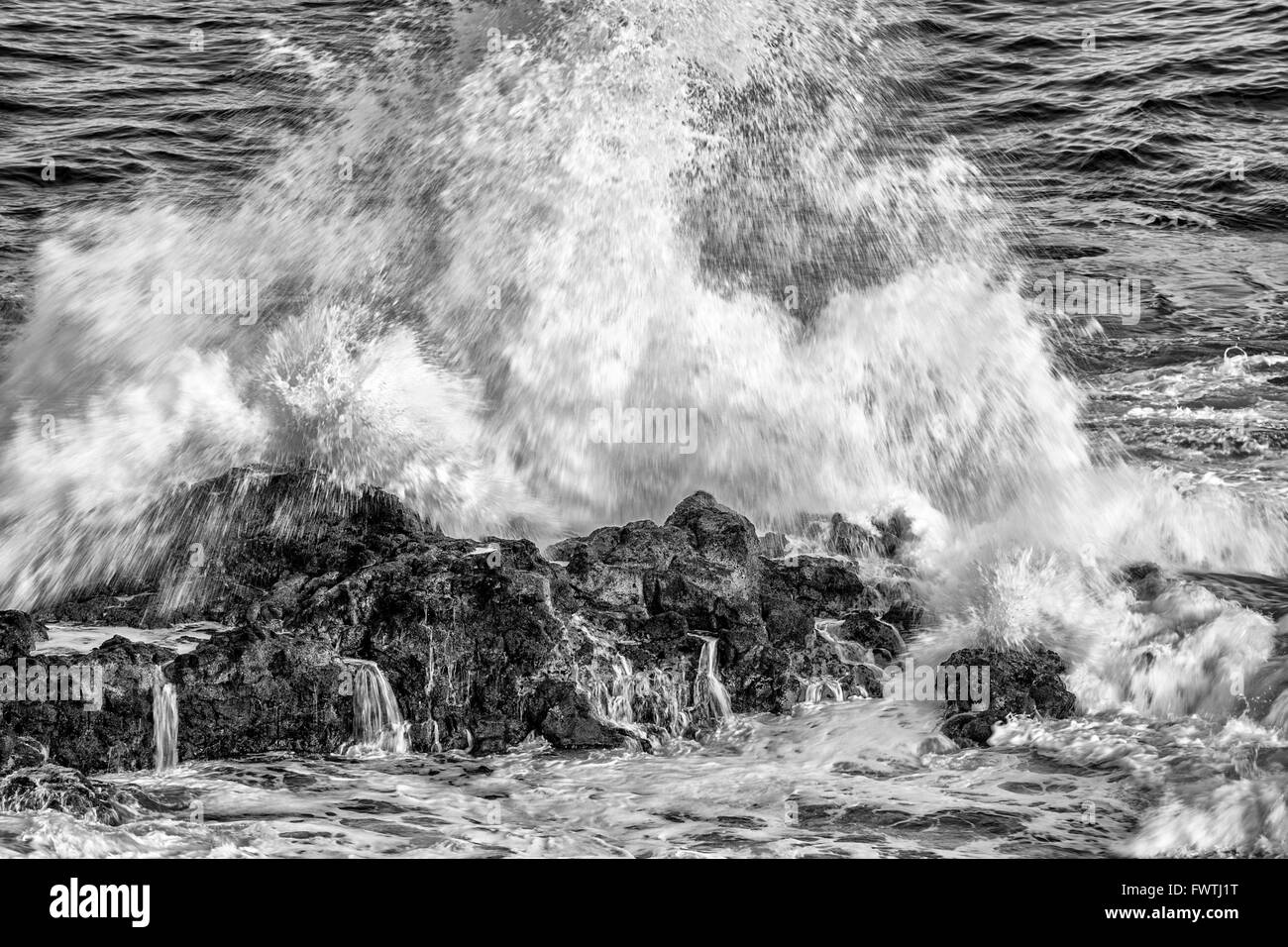 Water waves crashing on rocky Black and White Stock Photos & Images - Alamy