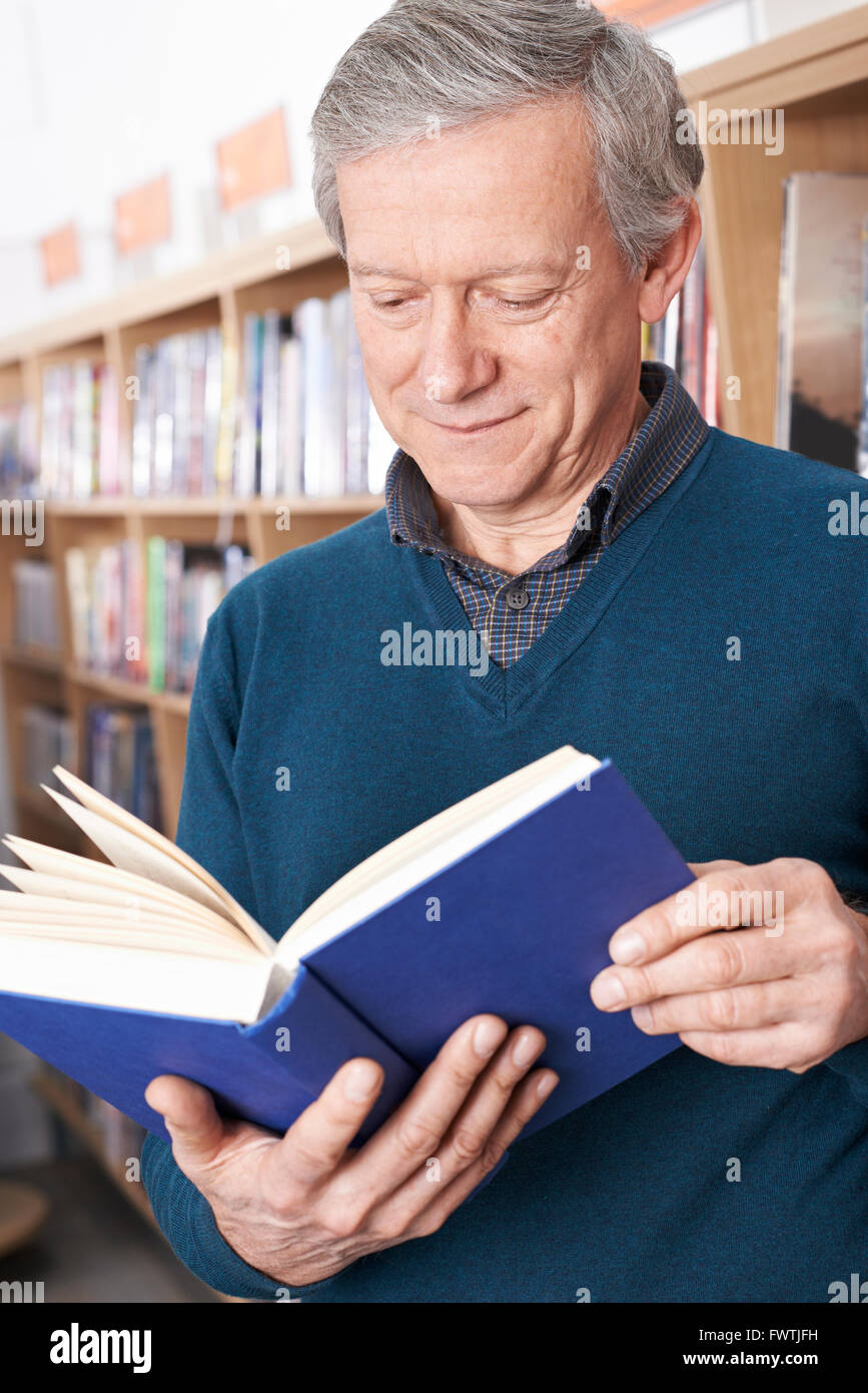 Mature student reading book hi-res stock photography and images - Alamy