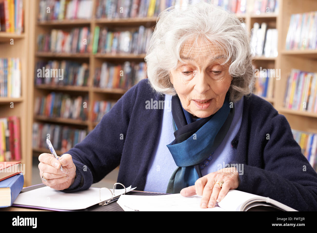 Senior Woman Studying In Library Stock Photo - Alamy