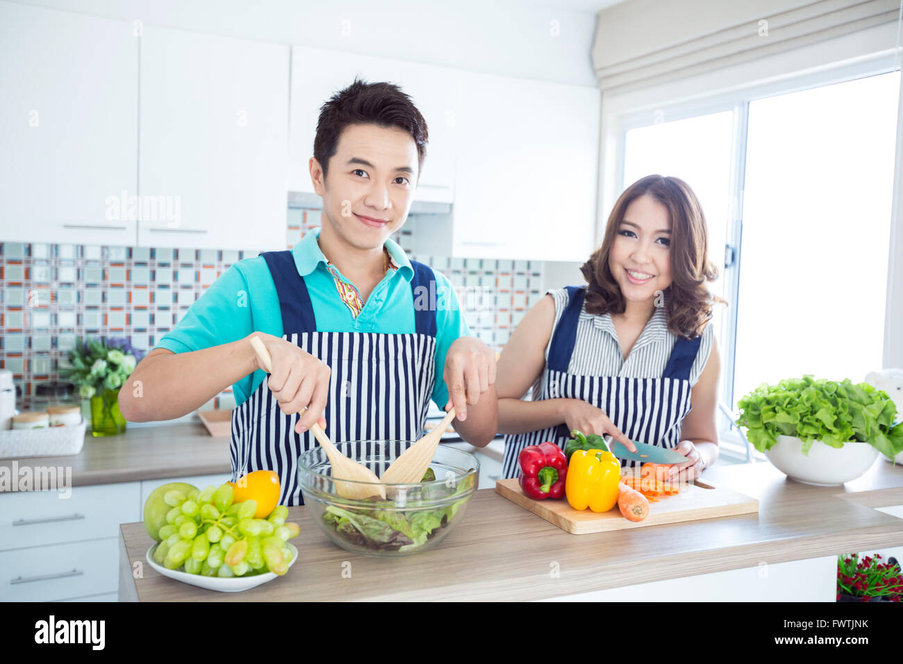 Young happy couples in domestic kitchen Stock Photo - Alamy