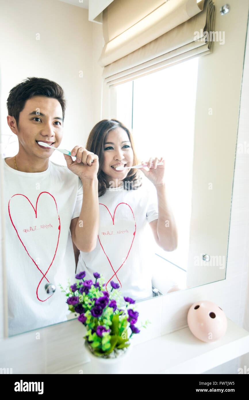 Happy smiling couple with toothbrushes Stock Photo - Alamy