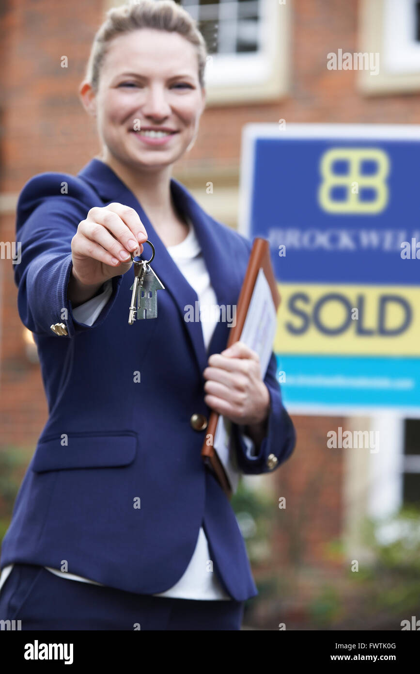 Female realtor holding sold sign hi-res stock photography and images ...
