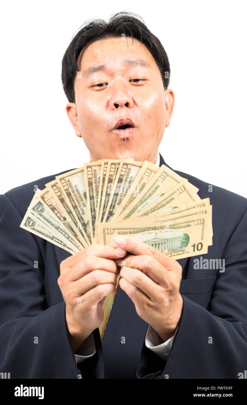 Businessman holding money isolated over white background Stock Photo ...