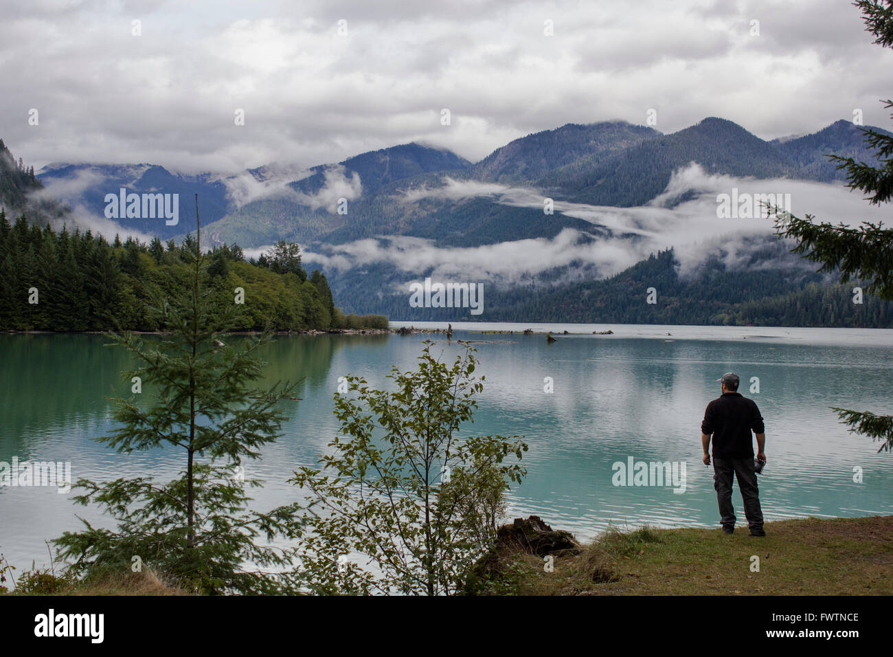 Man Looking Out at Lake Stock Photo - Alamy