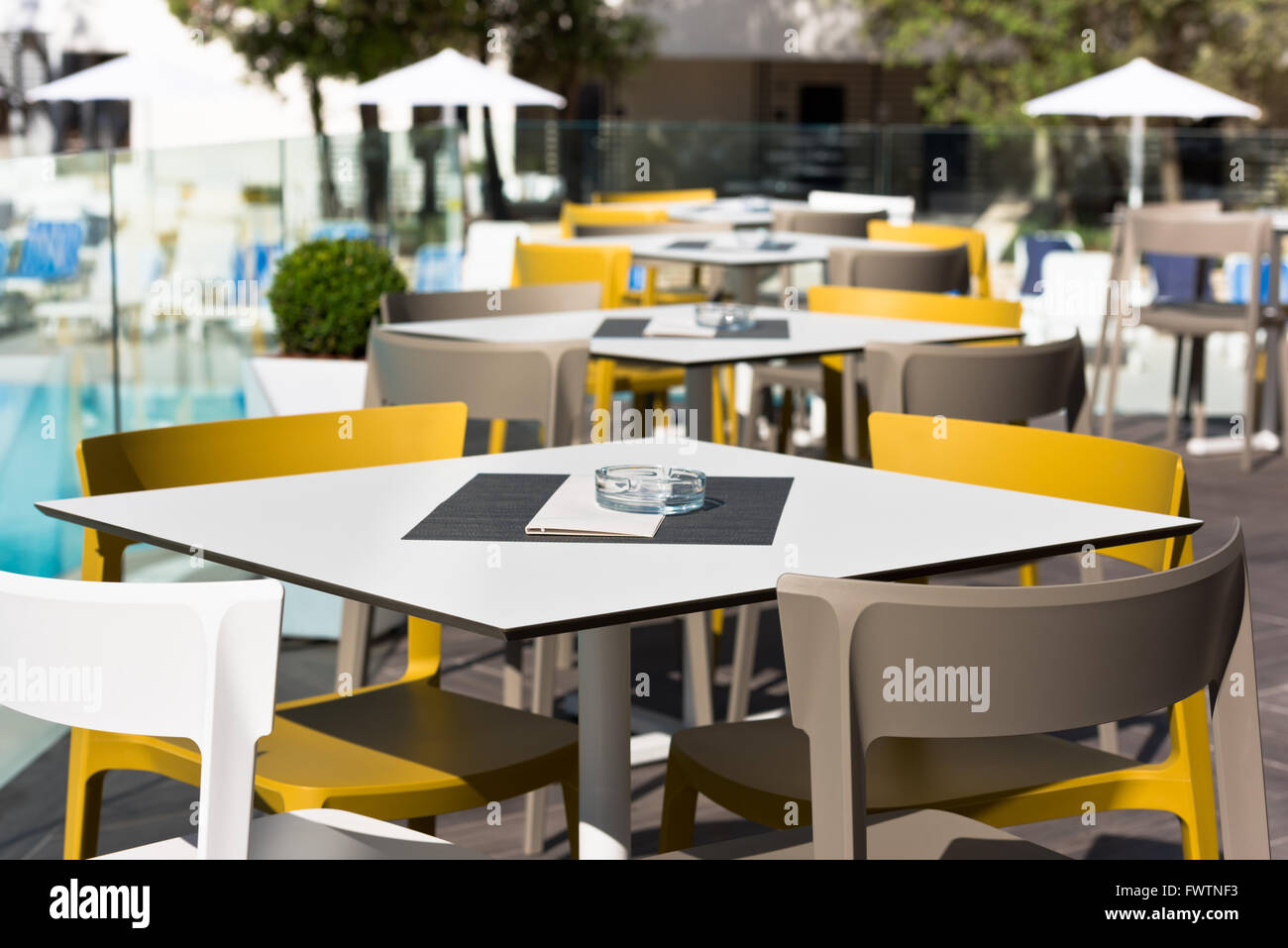 Summer cafe with plastic furniture near swimming pool Stock Photo - Alamy