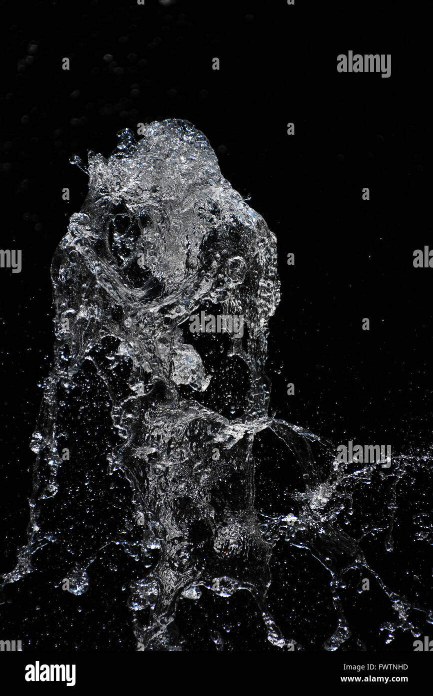 Fountain transparent water stream, splash and drops in motion over ...