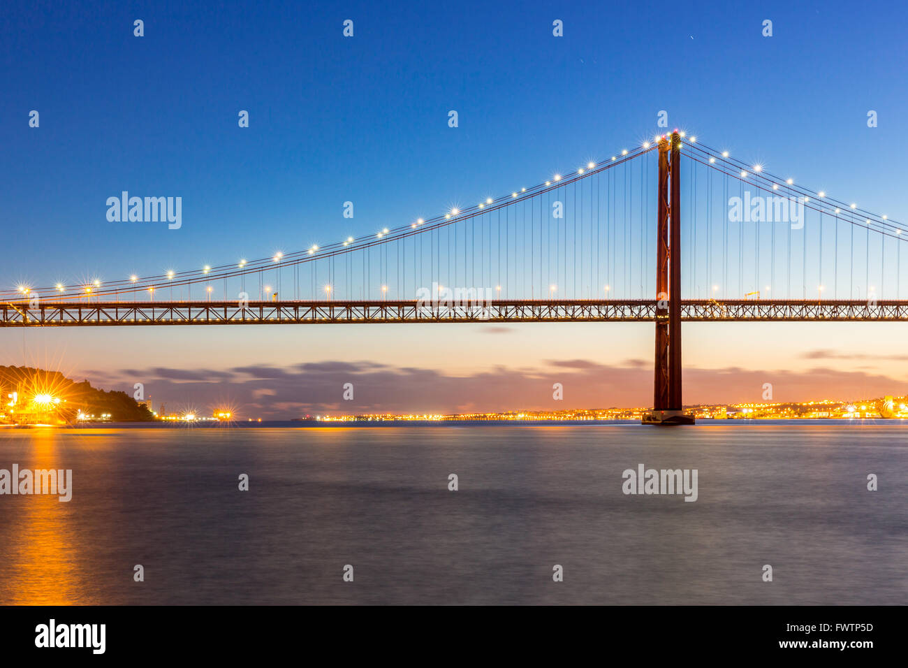 Lisbon cityscape with 25 de Abril suspension Bridge, Portugal at dusk ...