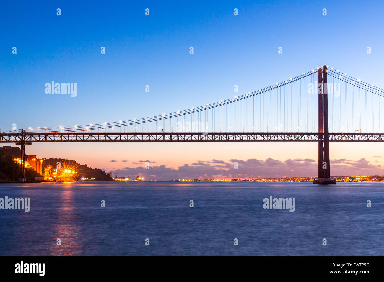 Lisbon cityscape with 25 de Abril suspension Bridge, Portugal at dusk ...
